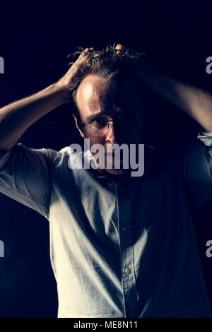 Caucasian man with eyeglasses look stressed Stock Photo - Alamy