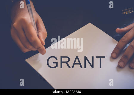 GRANT word, text written on a blank sheet of a notebook. View from ...