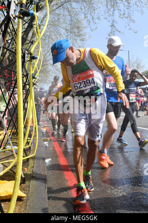 Runners use showers to cool off during the 2018 Virgin Money London ...