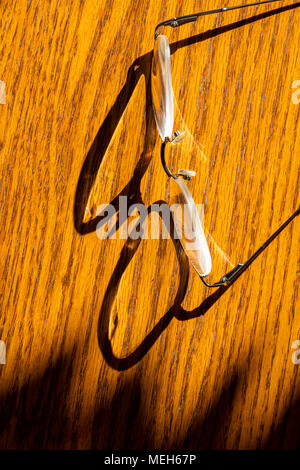 Early morning sunlight casts graphic shadows on wooden table Stock ...