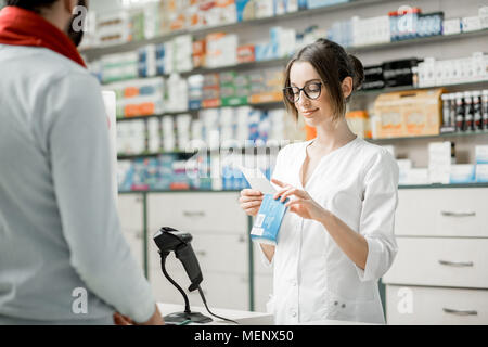 Man and woman pharmacist reading pills label bottle and prescription at ...