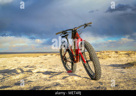 mountain fat bike in badlands with storm clouds in background - Main ...