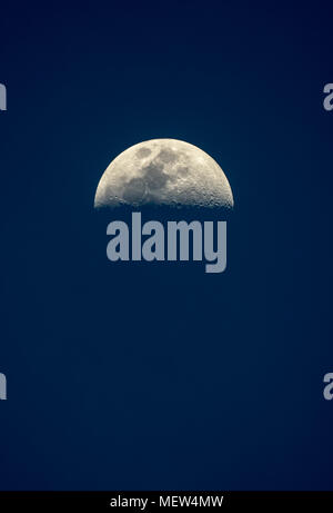 bright half moon in blue night sky Stock Photo - Alamy