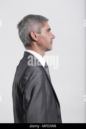 side view of proud man with suitcase looking to side and walking in ...