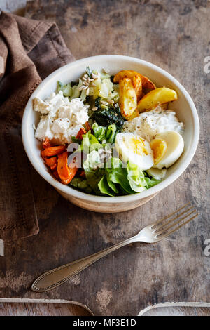 Baked potato wedges in a bowl on wooden table. Delicious lunch Stock ...