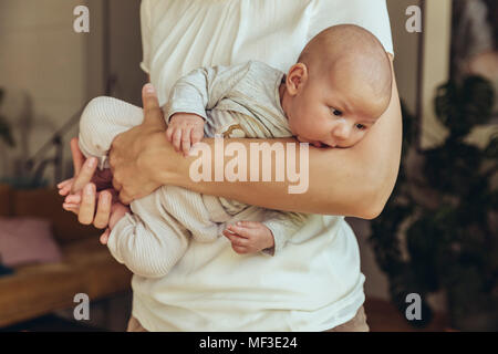A newborn baby being held in the arms of her mother Stock Photo - Alamy