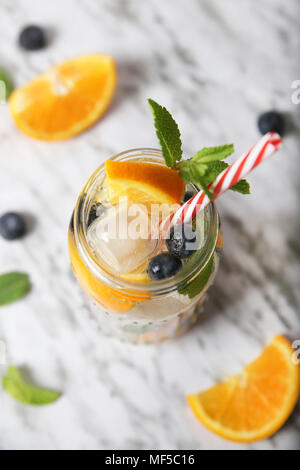 high angle view of glasses with iced citrus tonic and cut lemons on ...