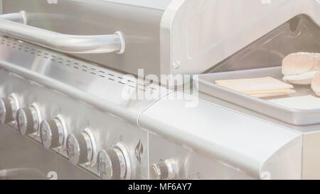 Step by step. Burger buns on the tray next to outdoor gas grill Stock ...