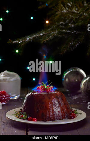 Plate of flaming Christmas pudding Stock Photo - Alamy