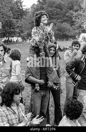 Hippies hippy men and women people playing frisbee in a communal garden ...