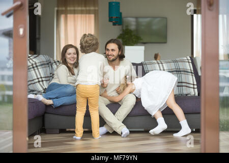 Happy family with kids, having fun outdoor in the snow on Christmas ...