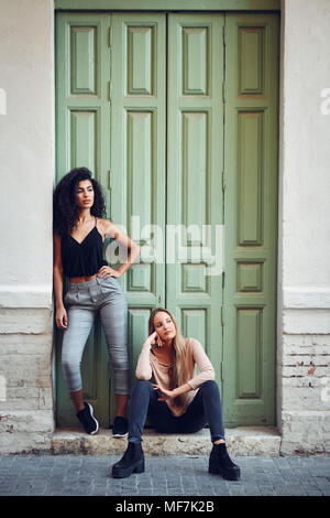 Two people waiting on the steps of a staircase Stock Photo - Alamy