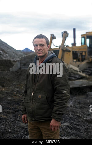A Stuart Schmidt Gold Mining employee cleans gold at their operation ...