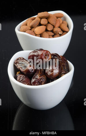 Dates fruit stuffed with almonds and nuts and topped with sesame seeds ...