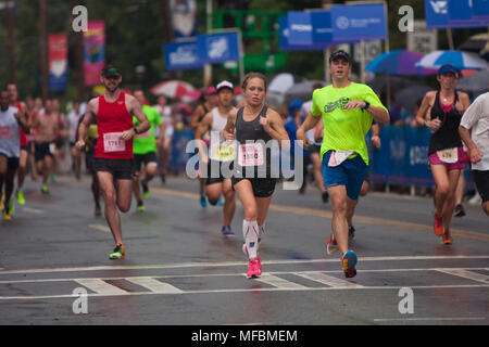 Tired and exhausted runners cross the finish line during the Worthing ...