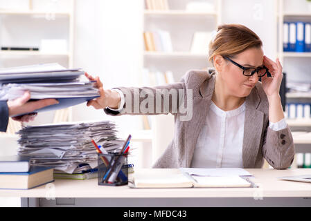Businesswoman very busy with ongoing paperwork Stock Photo - Alamy