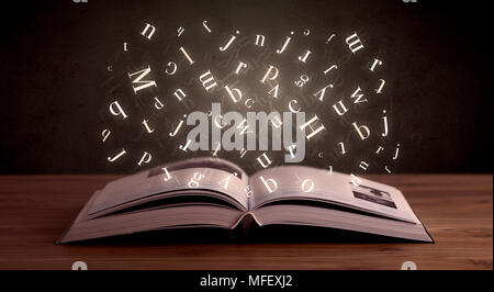 Glowing white alphabet letters coming out of an open book Stock Photo ...
