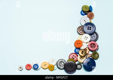 multi-colored buttons lie on a blue surface Stock Photo - Alamy