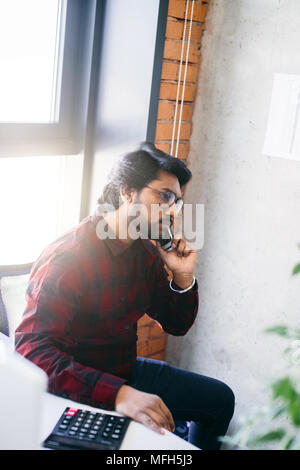 A closeup shot of side view of beautiful puma with a tree in the ...