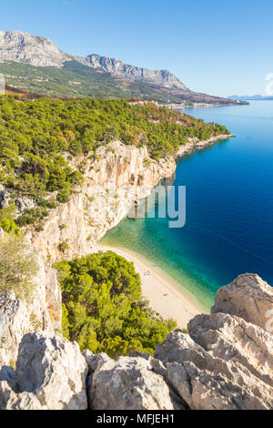 A high-angle of Nugal beach view on a sunny day, rocky cliffs and clear ...