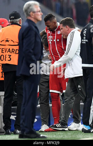 Munich's Jerome Boateng leaves the field after suffering an injury ...
