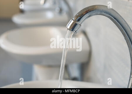 Public water taps in the school's toilet Stock Photo - Alamy