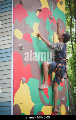 portrait of man on artificial climbing wall Stock Photo - Alamy
