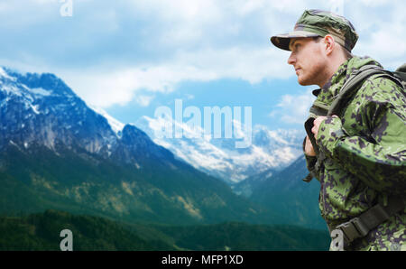 soldier in military uniform with backpack hiking Stock Photo - Alamy