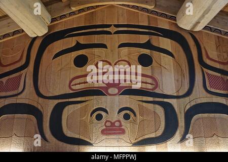 Tlingit totem pole with clan house in the background at the Totem Bight ...