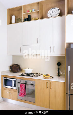 Hob and oven in fitted corner unit in modern kitchen Stock Photo - Alamy