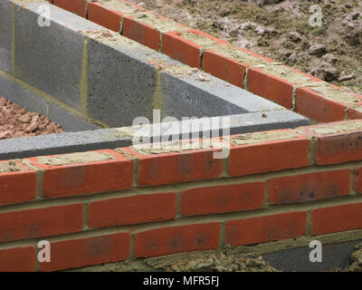 Bricks & thermalite bricks built up to the damp course in a wall Stock ...