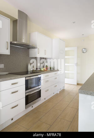 Stainless steel extractor fan above pan on hob in modern kitchen Stock ...