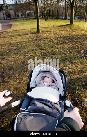 Baby being pushed in a pram / push chair being pushed by a small boy ...