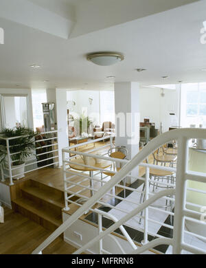 Modern split level dining room with steps up to kitchen area Stock ...