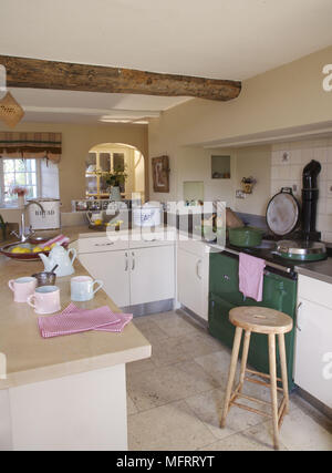 Country style kitchen with green Aga in fireplace recess Stock Photo ...