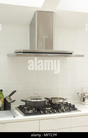 Extractor fan above gas hob set in island unit in modern kitchen Stock ...