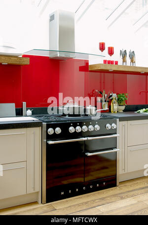 Extractor fan above range oven in contemporary kitchen with skylights ...