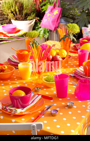 Table laid for lunch with brightly coloured tableware Stock Photo - Alamy