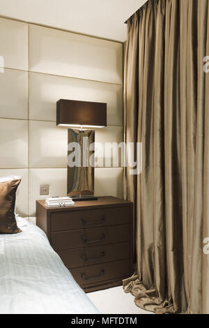Stylish bedroom interior detail with chest of drawers and objects on it ...