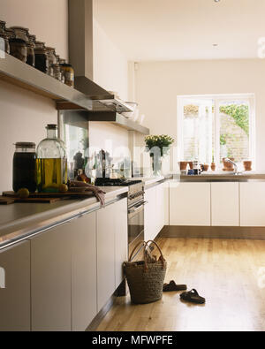 Integral oven in spacious kitchen with wood units Stock Photo - Alamy