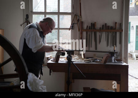 Early American gunsmith in his shop in Colonial Williamsburg Virginia ...