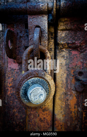 Rusted lock on a rusty metal post. Isolated closeup corroded padlock ...