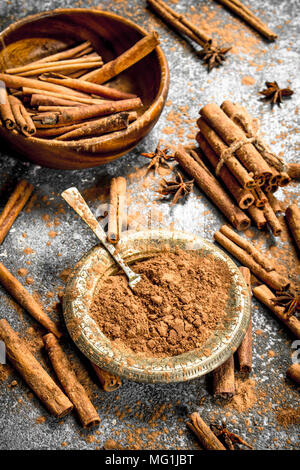 Ground cinnamon in bowls. On rustic background Stock Photo - Alamy