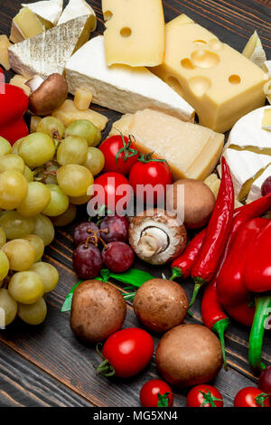 Cheese camembert or brie with chili pepper on dark background. Top view ...