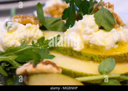 Goats cheese with walnuts and rocket leaves Stock Photo - Alamy