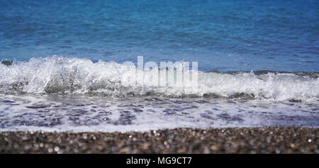 deep turquoise ocean wave with splashes and rip curl shot with ...