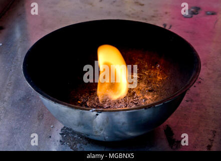 Coconut oil lamps in temple Stock Photo - Alamy