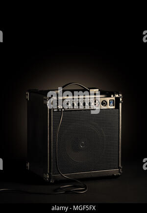 Plug jack with cable plugged into a black guitar combo amplifier Stock ...