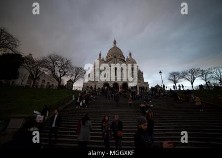 People climbing the stairs leading to the Sacre Coeur basilica in ...