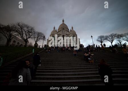 People climbing the stairs leading to the Sacre Coeur basilica in ...